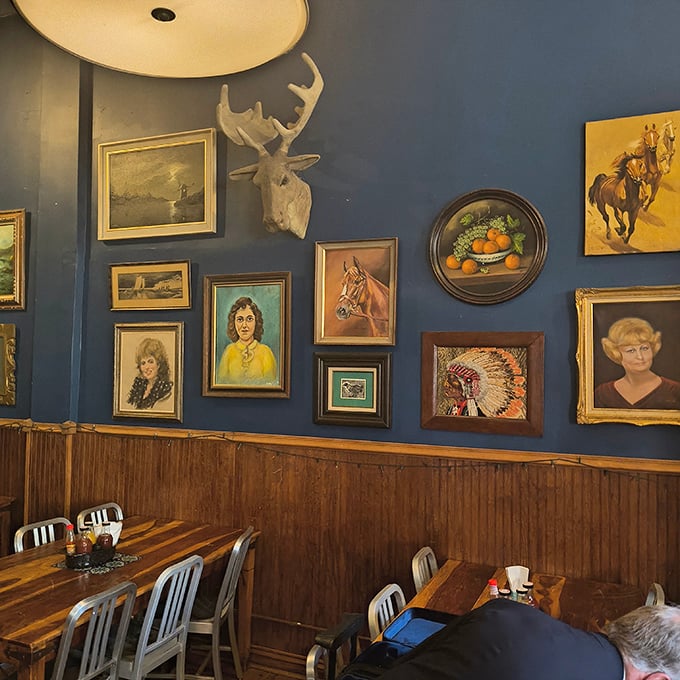 The eclectic wall art collection feels like raiding your coolest grandparent's attic &ndash; vintage portraits, wildlife mounts, and horse paintings creating a uniquely American tableau.