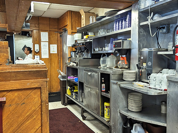 The kitchen visible through the pass, where culinary magic happens in plain sight, no smoke and mirrors needed.