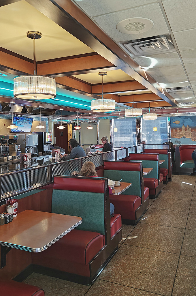 Classic diner booths in that perfect shade of red - where strangers become neighbors and calories don't count before noon.