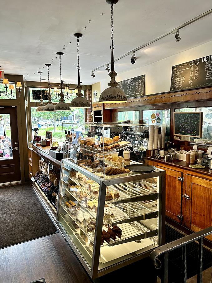 The pastry case—where willpower goes to die and happiness begins. Those pendant lights cast a spotlight on the true stars of the show.