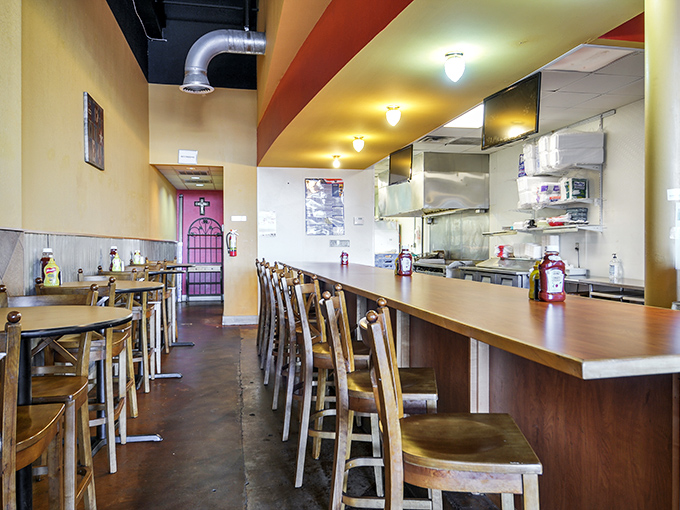 The counter seating offers a front-row view to the culinary action – where burger dreams materialize before your very eyes.