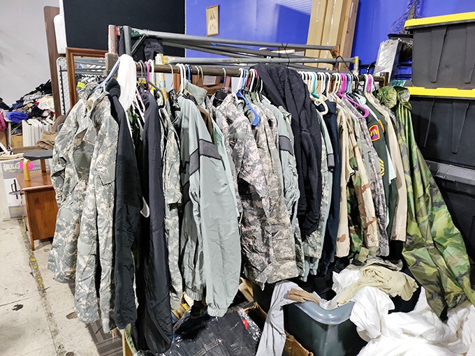 Military jackets and camo gear hanging like a regiment at attention, ready for their second tour of duty in someone's vintage wardrobe.