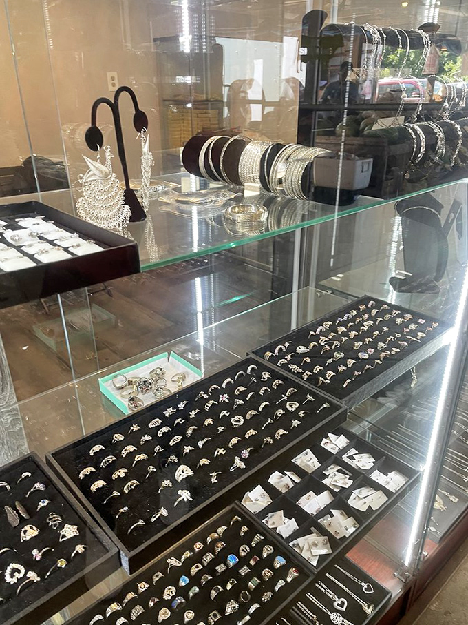 Silver sparkles under glass cases where rings wait in neat rows, each one hoping to be the treasure someone didn't know they were searching for.