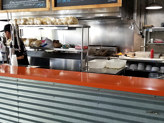 Behind the counter, where the magic happens. Those Cuban rolls aren't stacking themselves, folks &ndash; they're waiting to embrace some perfectly fried fish.