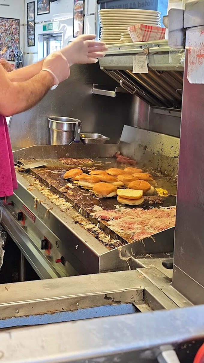 Behind the scenes where slider dreams come true&mdash;those buns steaming while patties sizzle with onions pressed right in.