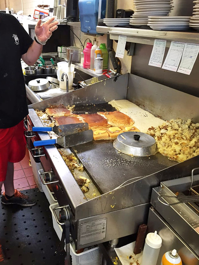 Behind the magic! The flat-top grill has probably cooked enough eggs to circle the globe, operated by hands that know exactly when to flip that pancake.