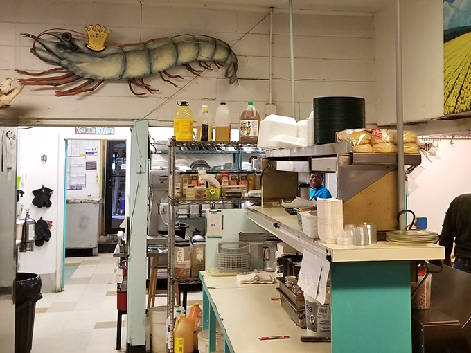 Behind every great seafood joint is a kitchen where magic happens. That giant shrimp mural watching over the cooks is both guardian and inspiration.