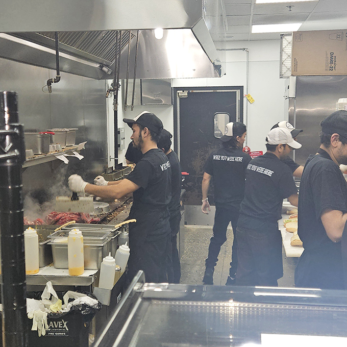 The kitchen crew in their element, wielding spatulas like conductors' batons. This is where the magic happens, one sizzling ribeye at a time.