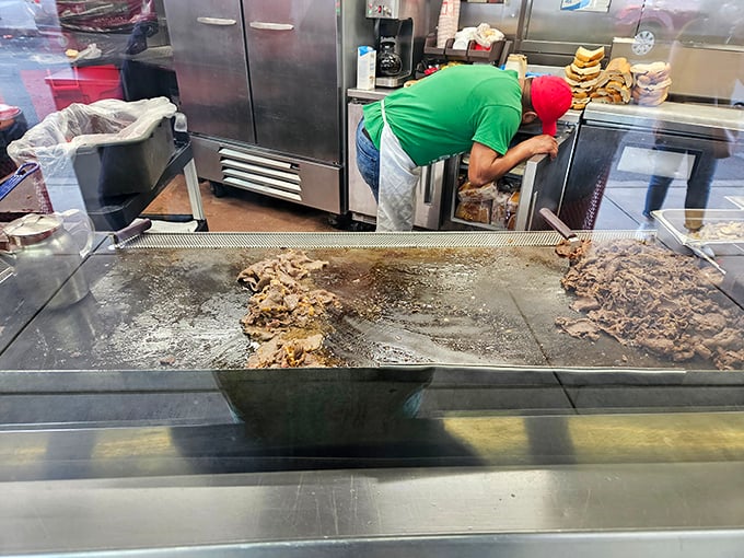 Behind the scenes where the magic happens: thinly sliced beef sizzling on a well-seasoned flat-top that's seen decades of service.