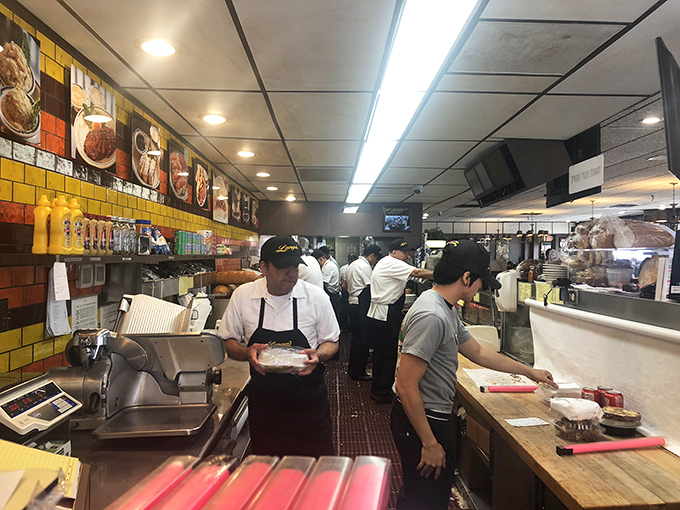 The kitchen at Langer's moves with the precision of a ballet and the urgency of a newsroom. This is where the magic happens.