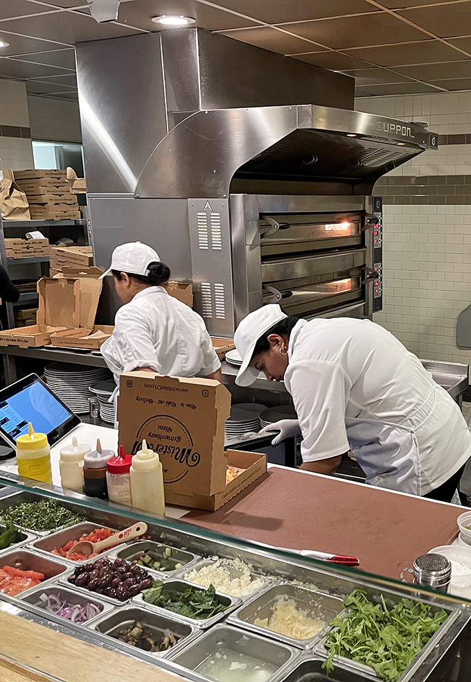 Behind every great pizza is a team of dedicated professionals and an impressive lineup of fresh ingredients standing at attention like colorful soldiers.