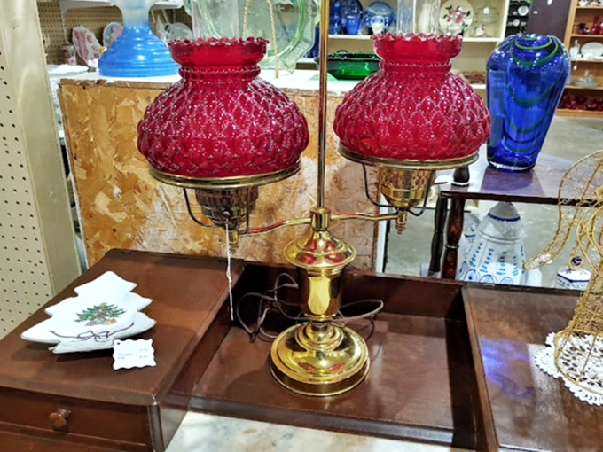 This isn't just a lamp; it's a conversation piece waiting to illuminate your living room with its ruby-red glow and brass personality.