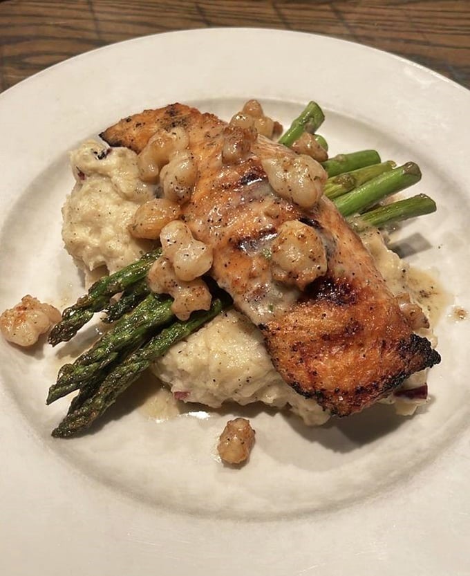 Salmon perched atop asparagus spears and creamy potatoes, with corn relish that adds sweetness to every perfect bite.