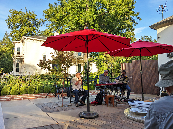 Outdoor dining under red umbrellas&mdash;where live music and fresh air conspire to make your steak taste even better.