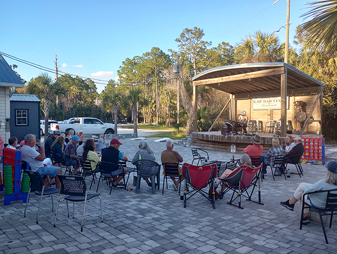 The outdoor music area where local tunes complement the coastal breezes – proving that good seafood tastes even better with a soundtrack.