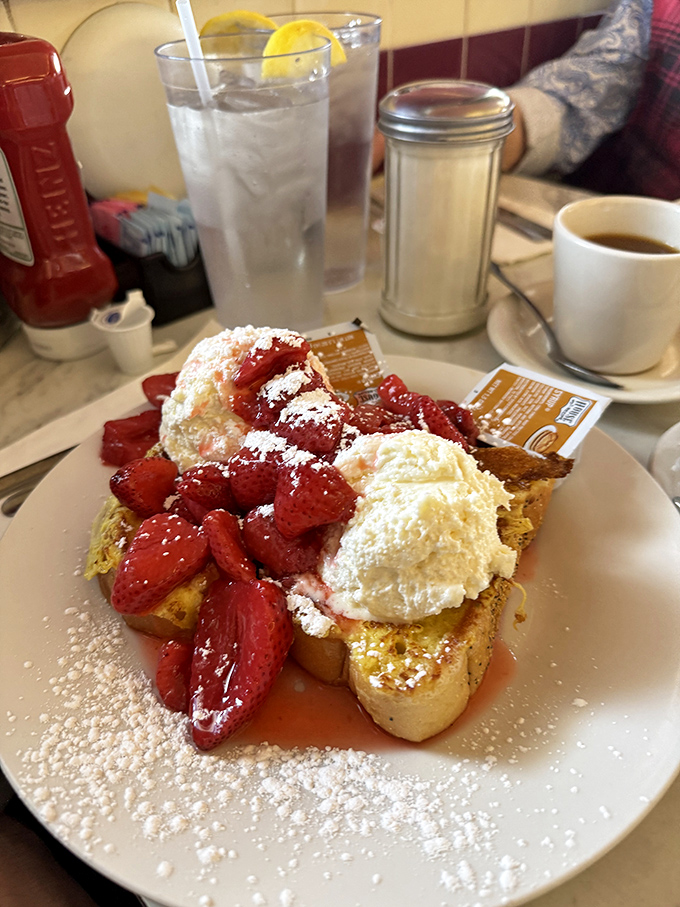 French toast that crossed the line into dessert territory, topped with strawberries and whipped cream that make "breakfast for dinner" sound reasonable.