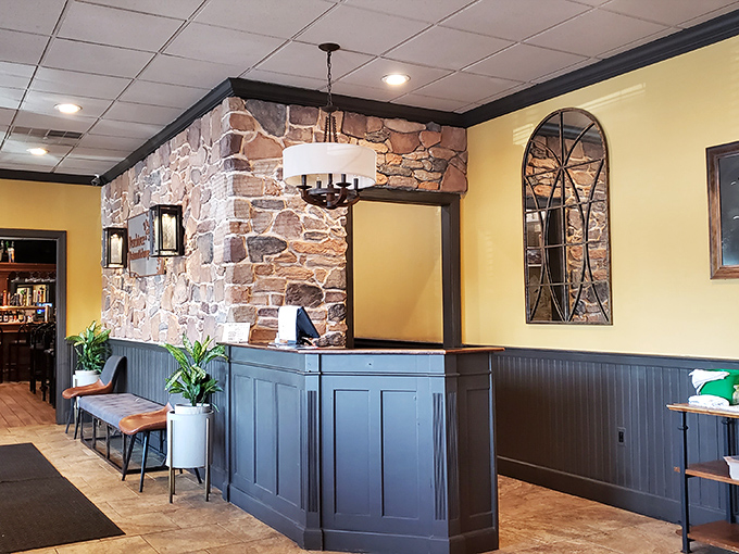 The reception area blends rustic stone with modern touches. Like walking into someone's really well-designed living room, if that living room served prime rib.