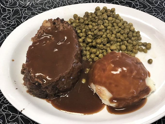 Meatloaf that would make your mother jealous, bathed in rich brown gravy. Those peas aren't just a side—they're keeping very prestigious company.