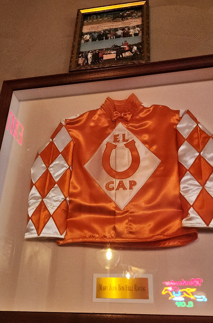 A framed jockey silk reveals El Cap's namesake racing heritage. Every great restaurant has a story hanging on its walls.