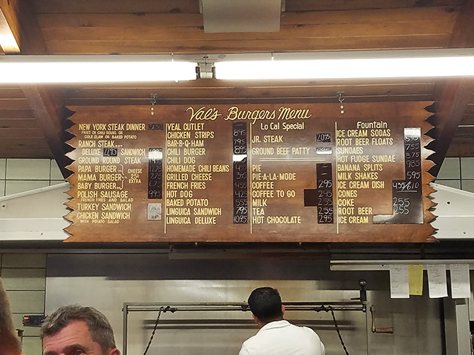 The menu board hangs like a sacred text. Simple offerings written in gold, promising satisfaction without the need for fancy culinary terms.