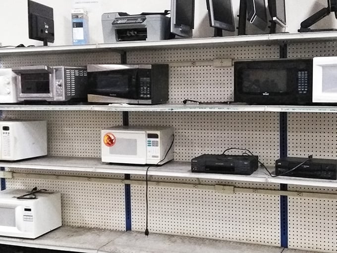 Microwave row&mdash;where kitchen appliances line up like hopeful contestants on a dating show, each one ready to heat up someone's leftovers with dignity.