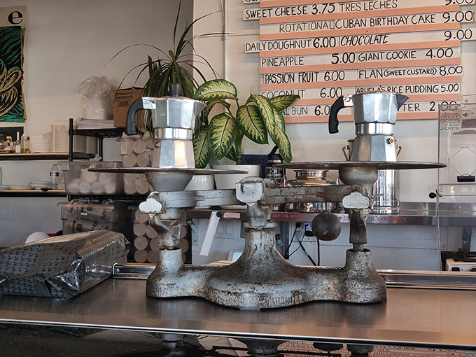 Vintage moka pots perch on an old-school scale, silent witnesses to decades of brewing excellence and morning rituals.