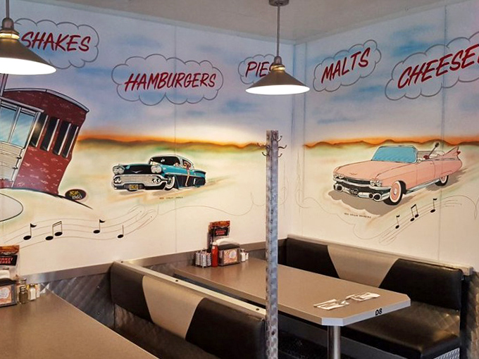 Vintage cars and classic diner fare dance across hand-painted murals, reminding you that some American traditions are worth preserving.