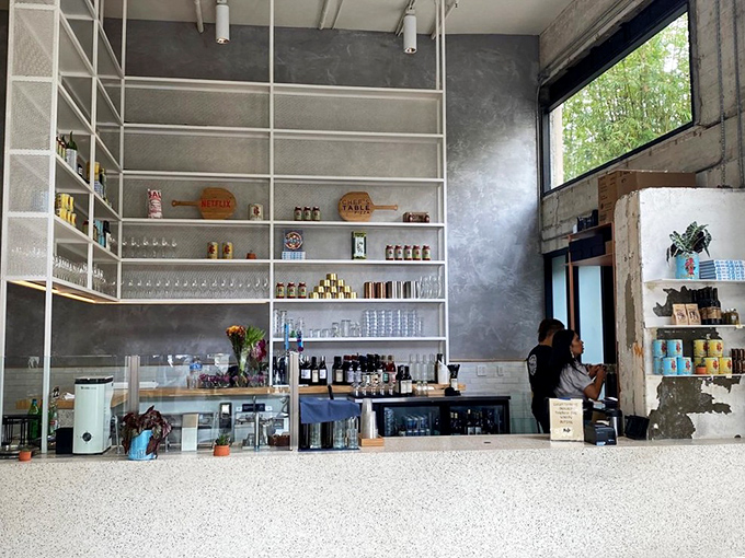 The order counter: minimalist, efficient, and backed by shelves that suggest they take their beverages as seriously as their dough.