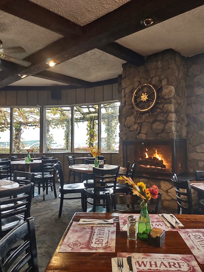 A fireplace and ship's wheel combo that says "cozy nautical" without trying too hard to be either.