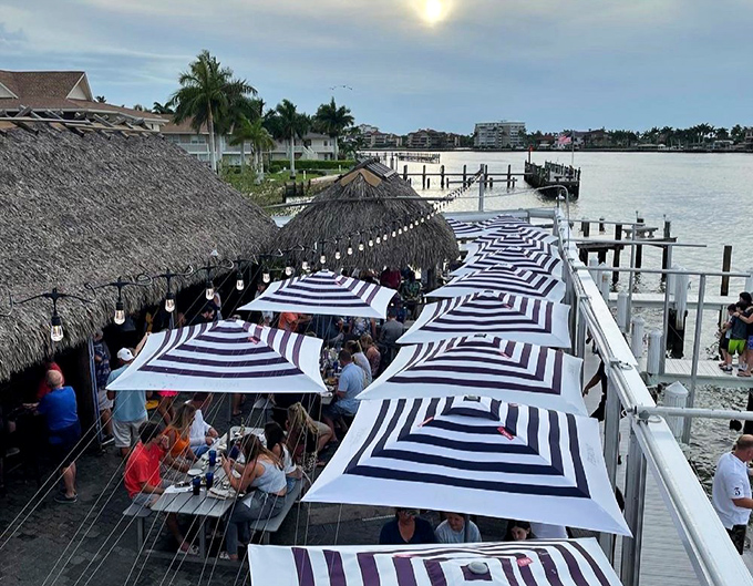 Outdoor dining under striped umbrellas &ndash; like being at the world's most delicious beach club without membership fees.
