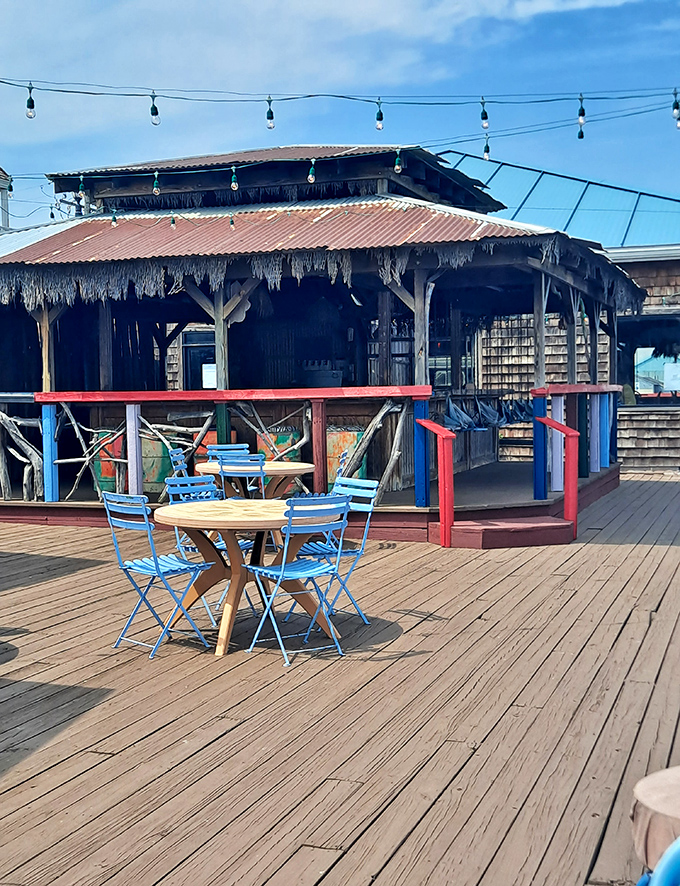 The outdoor deck where fresh air enhances every bite. Those blue chairs aren't just seating&mdash;they're front-row tickets to relaxation.