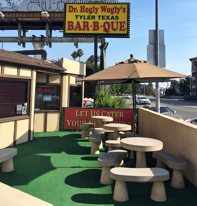The outdoor patio&mdash;where the green astroturf and concrete tables say "we put our effort into the smoker, not the landscaping."