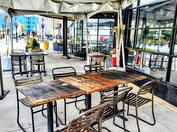 The outdoor patio features rustic wooden tables that have clearly hosted countless celebrations, first dates, and "just because it's Tuesday" dinners.