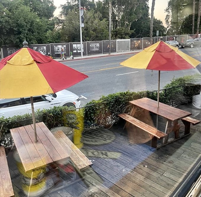 Outdoor seating with red and yellow umbrellas that match the train car's vibrant colors&mdash;because even your al fresco dining should stay on brand.