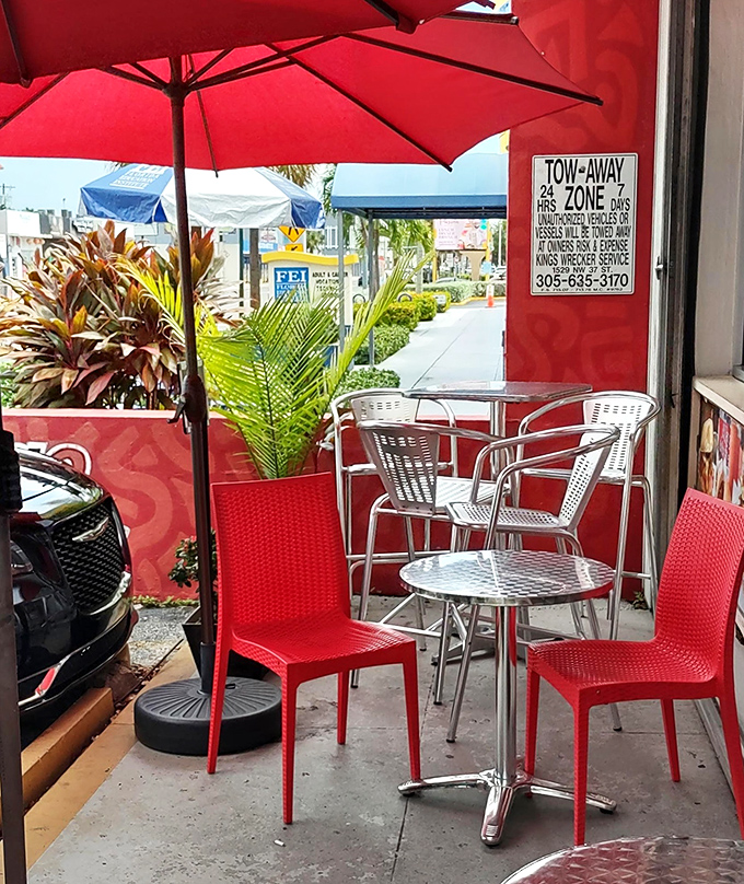 Miami's perfect weather deserves outdoor seating like this&mdash;red umbrellas providing shade while you contemplate ordering seconds.