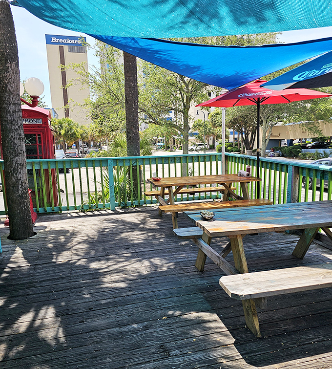 Outdoor seating under blue shade sails where ocean breezes enhance every bite. This is what lunch breaks dream of becoming.