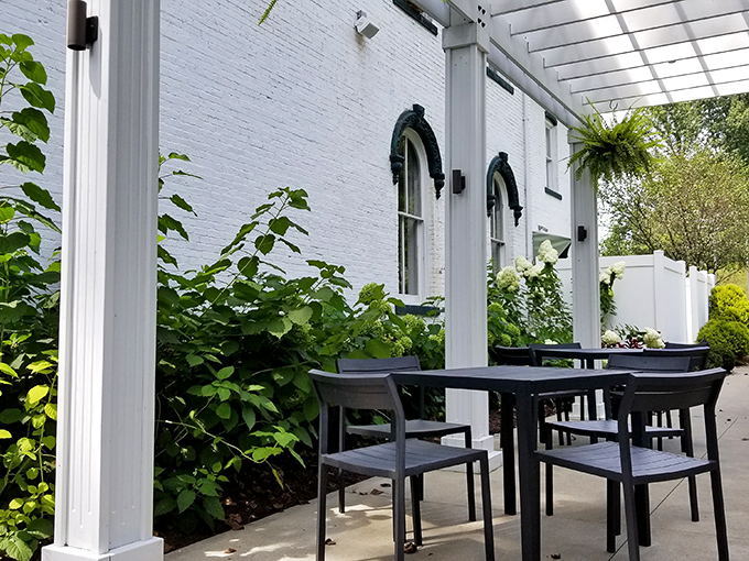Dine al fresco among lush greenery where the mansion's white exterior provides a stunning backdrop for summer meals under Ohio skies.