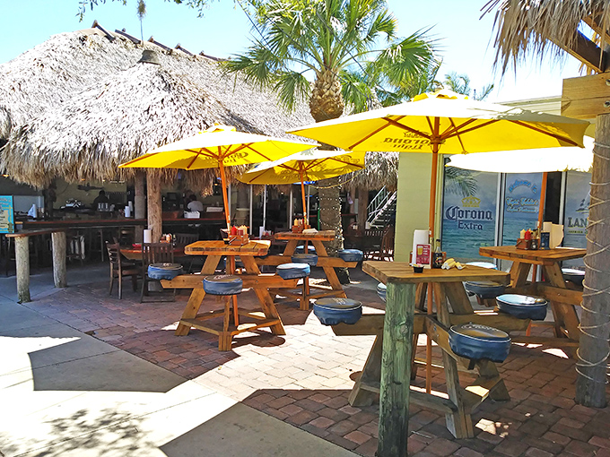 Outdoor seating under yellow umbrellas where the sunshine is free and the vibes are priceless.