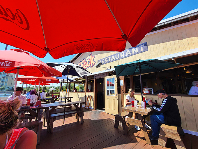 Red umbrellas create islands of shade on the deck where diners savor both the food and the view. Florida dining as it should be.