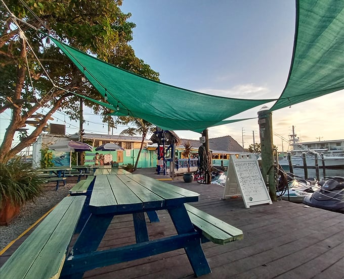 Waterfront dining under shade sails where the breeze carries both salt air and the promise of an afternoon nap.