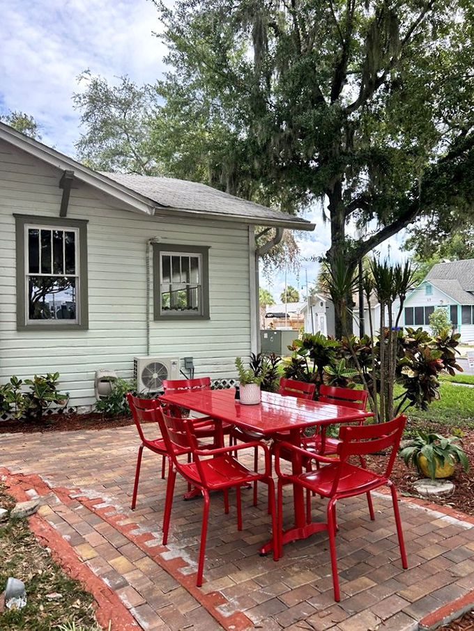 Those red chairs aren't just furniture&mdash;they're an invitation to linger under Florida's oak trees with a coffee and watch the world go by.