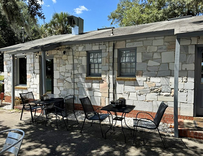 Outdoor tables where dappled sunlight filters through oak trees &ndash; nature's perfect dining companion.