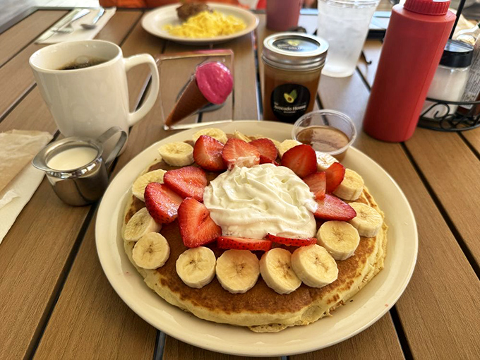 This pancake wears its fruit crown with pride, delivering childhood memories with every syrup-soaked, fluffy bite.