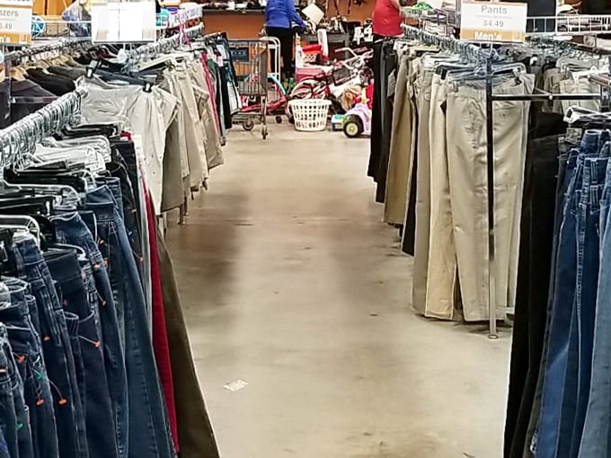 The pants aisle stretches toward infinity. Khakis and jeans stand at attention, waiting for their second chance at making someone look good.