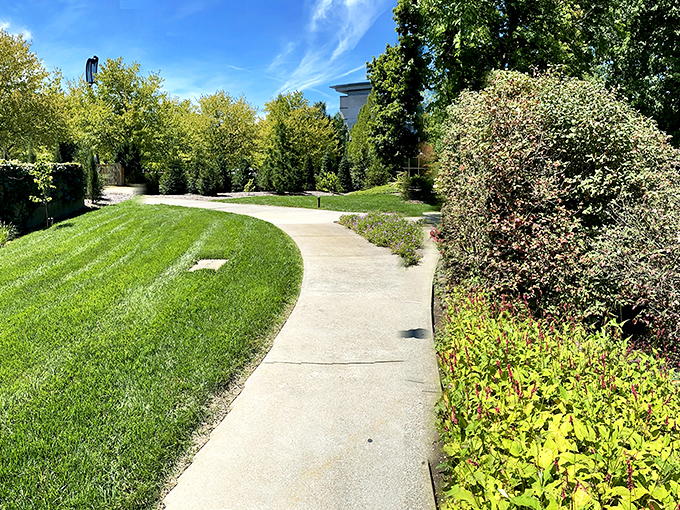 Winding paths that promise discovery around every bend. This manicured walkway invites exploration through perfectly maintained grounds.