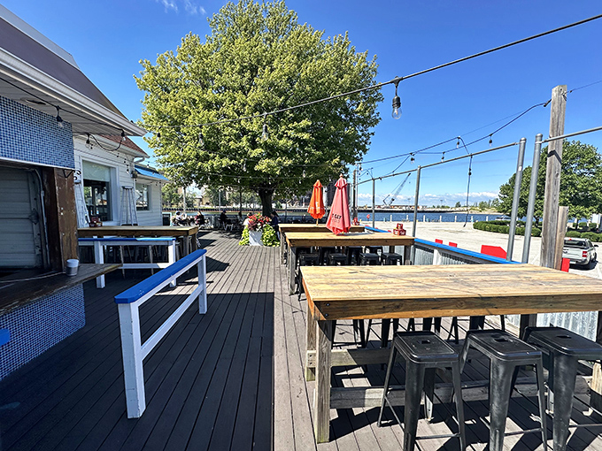 The outdoor deck offers waterfront dining with string lights overhead. It's where "I'll just have a quick lunch" turns into "Let's watch the sunset."
