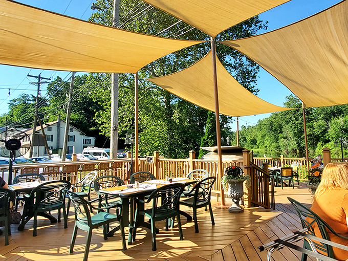 Those yellow shade sails turn the patio into an outdoor room where sunshine is invited but sunburn isn't.
