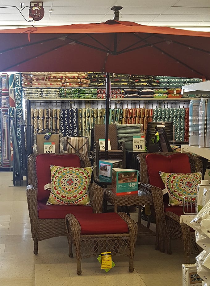 Patio paradise under a terra cotta umbrella &ndash; wicker chairs and vibrant pillows create backyard escapes for a fraction of specialty store prices.