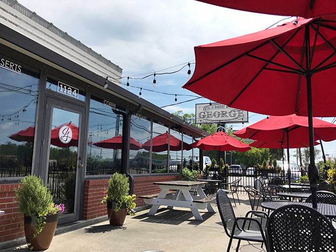 Patio seating under vibrant red umbrellas creates the perfect backdrop for that "I'm on vacation even though I live here" feeling we all occasionally need.