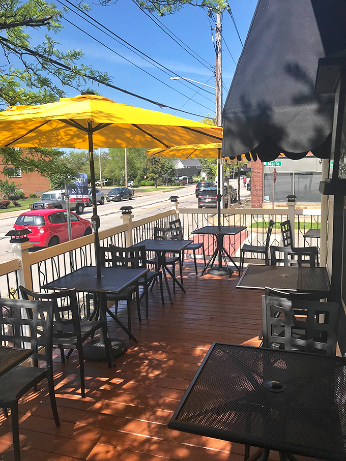 The sun-dappled patio with bright yellow umbrellas offers the perfect setting for pretending you're in a small Italian village instead of suburban Ohio.